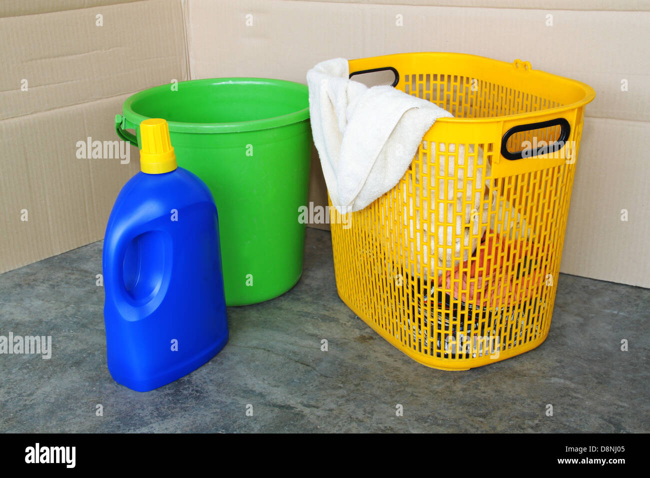 Detergent and pail for washing dirty laundry in the basket. Concept of ...