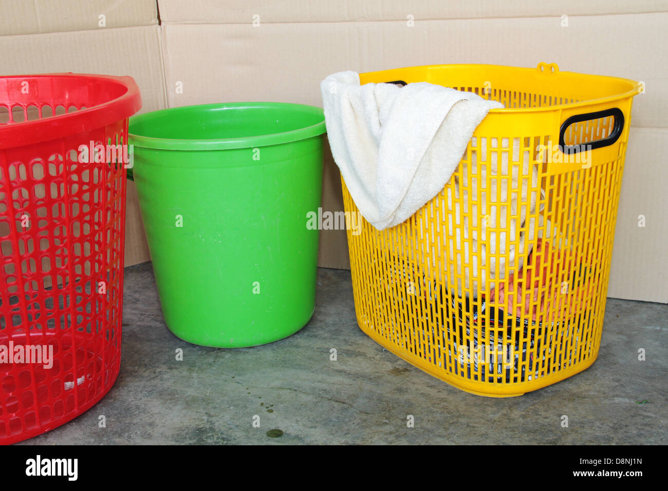 Dirty laundry in the basket for washing using plastic pail. Concept of ...