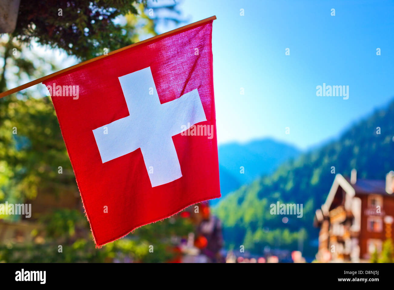Swiss flag on town background Stock Photo - Alamy