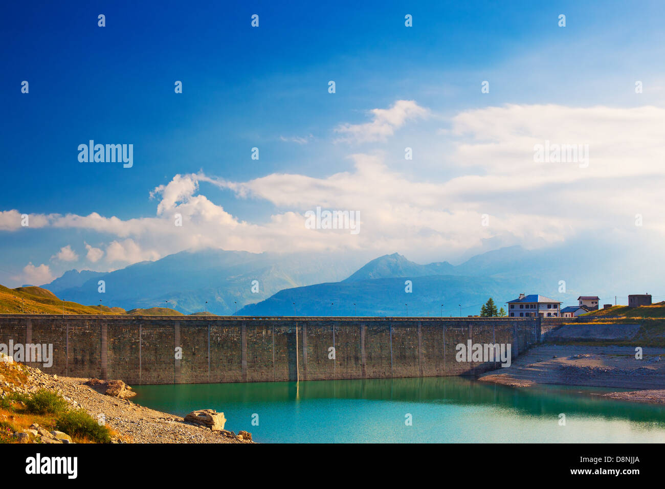 Mountain dam with water in Alps Stock Photo - Alamy
