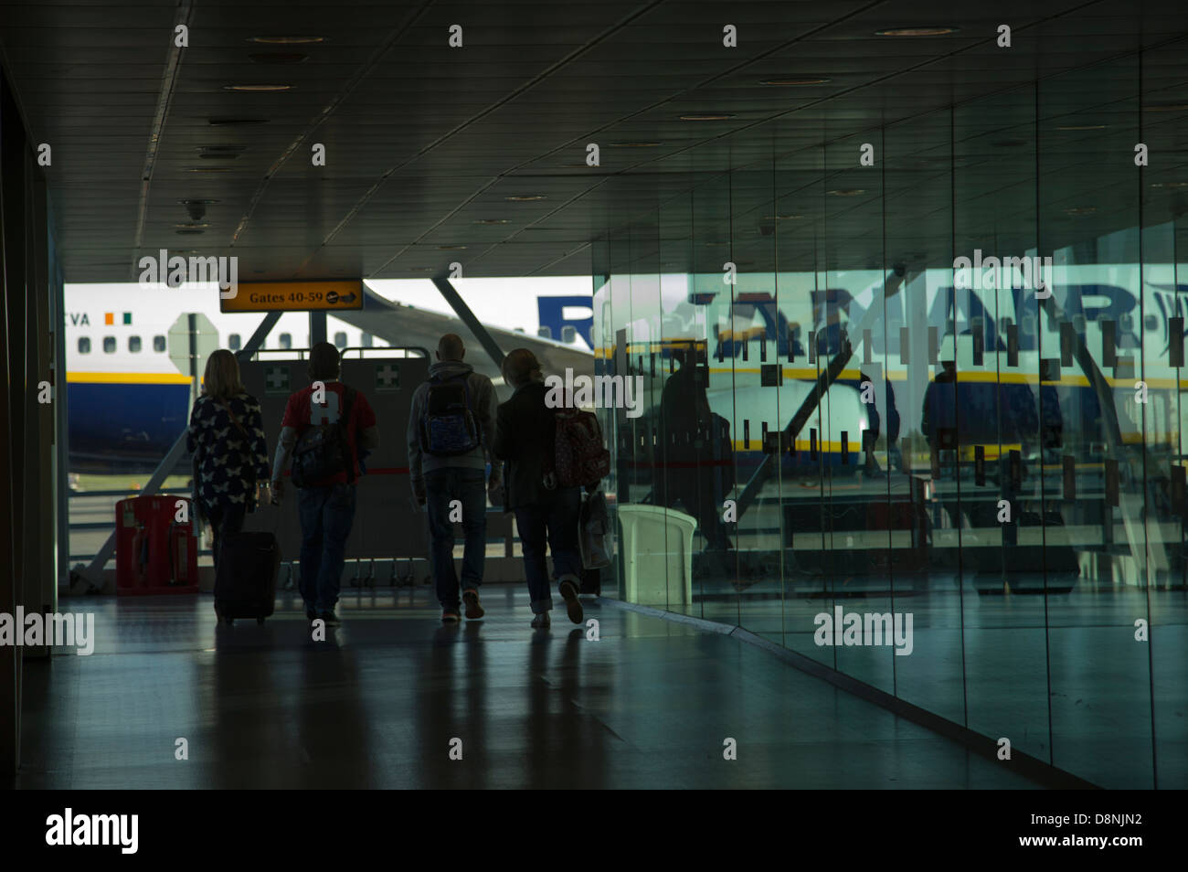 Paasengers walking to gate at Stansted terminal Stock Photo - Alamy