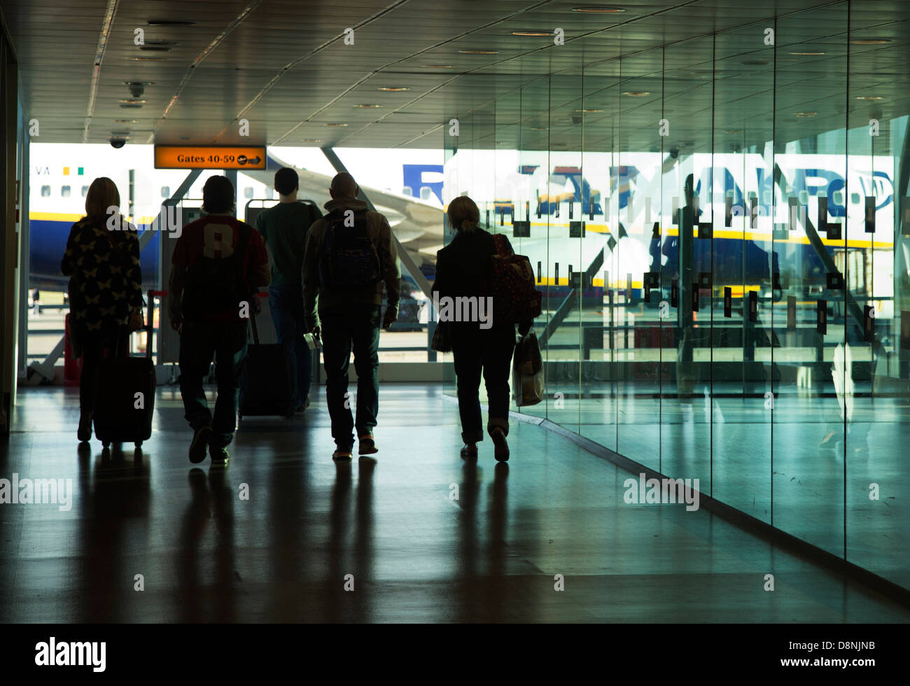 Paasengers walking to gate at Stansted terminal Stock Photo - Alamy