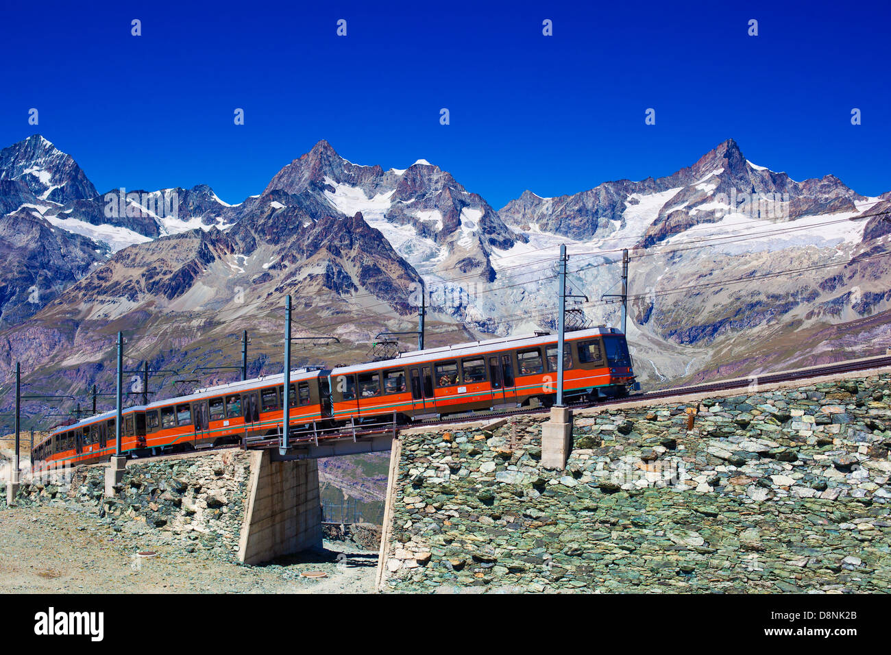 Train in high Alps mountains Stock Photo - Alamy