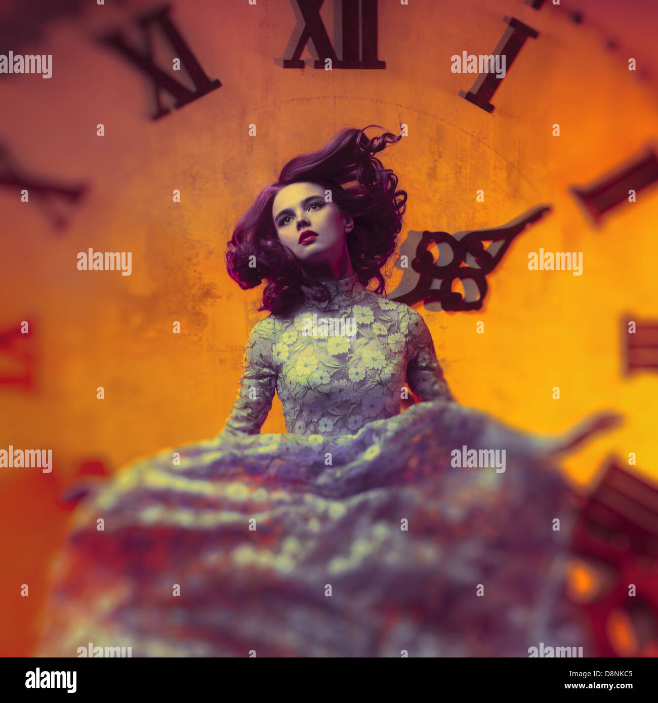 Young woman on clock background Stock Photo - Alamy