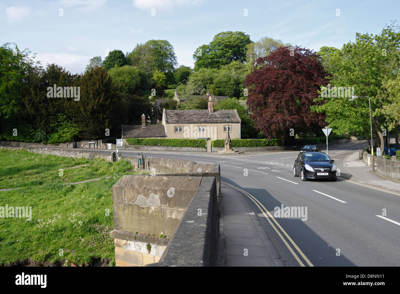 The road entering Bakewell Derbyshire England. over the medieval river ...