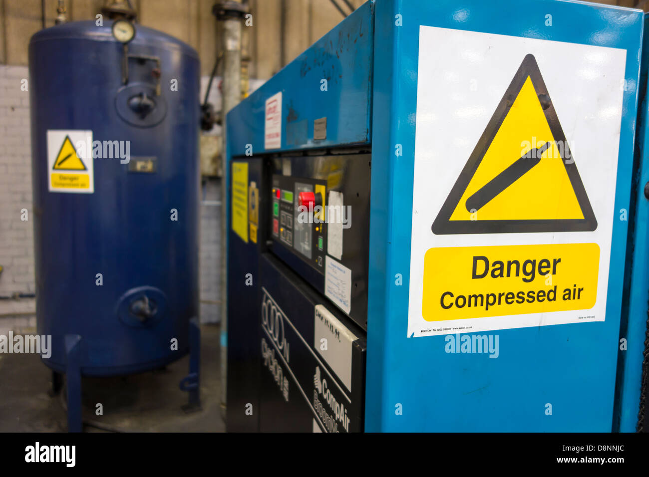 Air compressor and air storage cylinder or vessel with warning signs ...