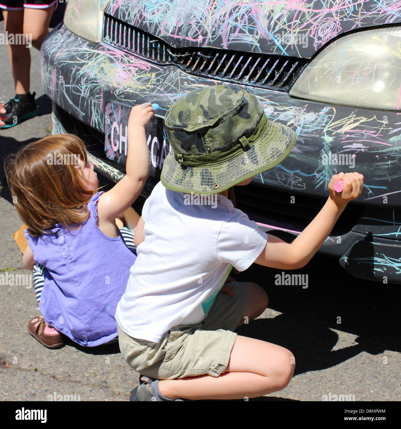 Berkeley, California USA - June 1, 2013 Two children draw on the 'chalk ...