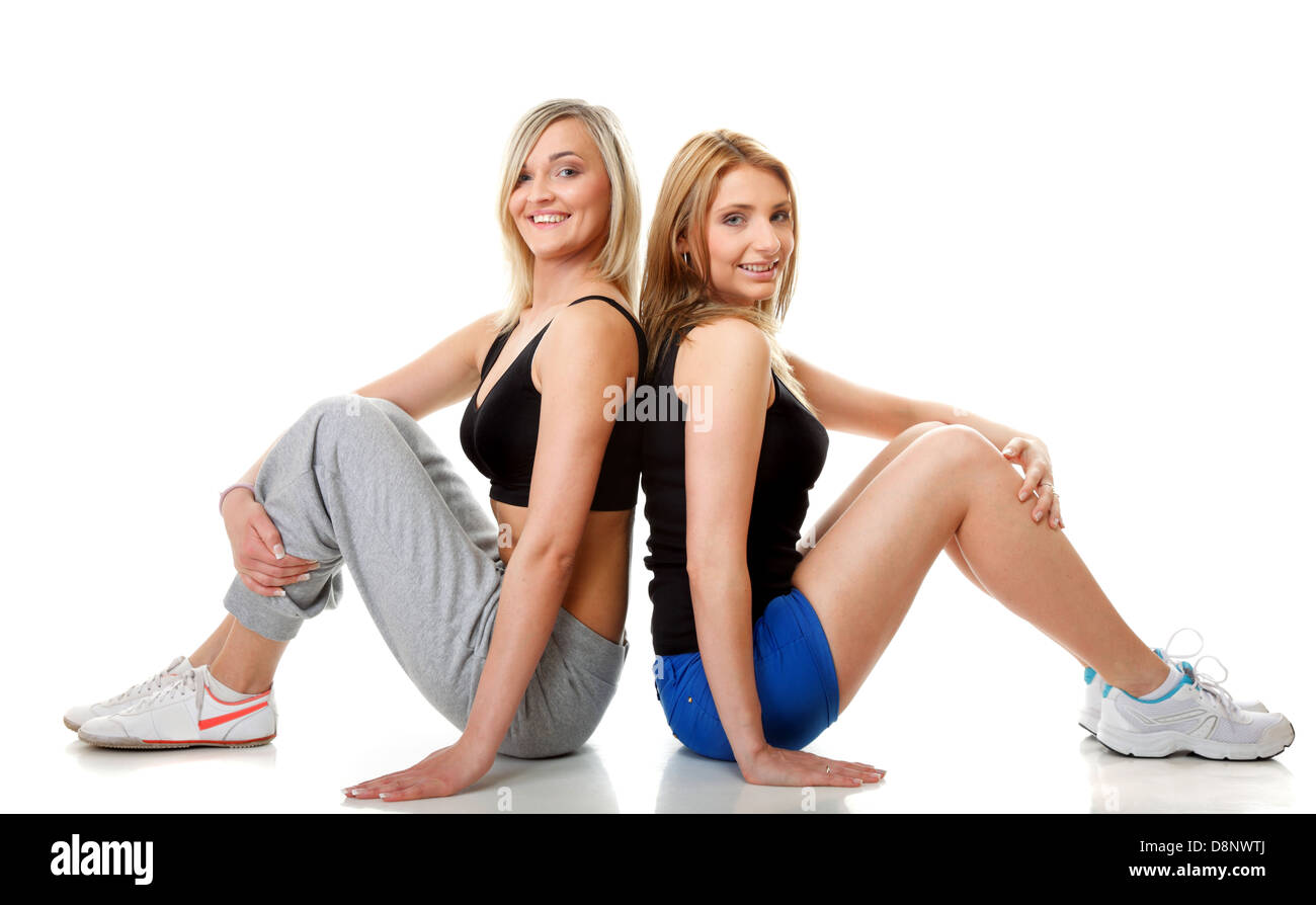 Full length two young sporty women after intense workout, isolated on ...