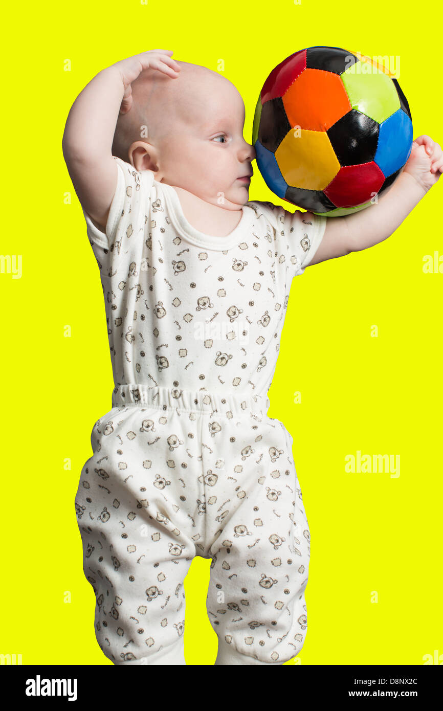 Baby boy playing with a soccer ball on color background Babies And ...