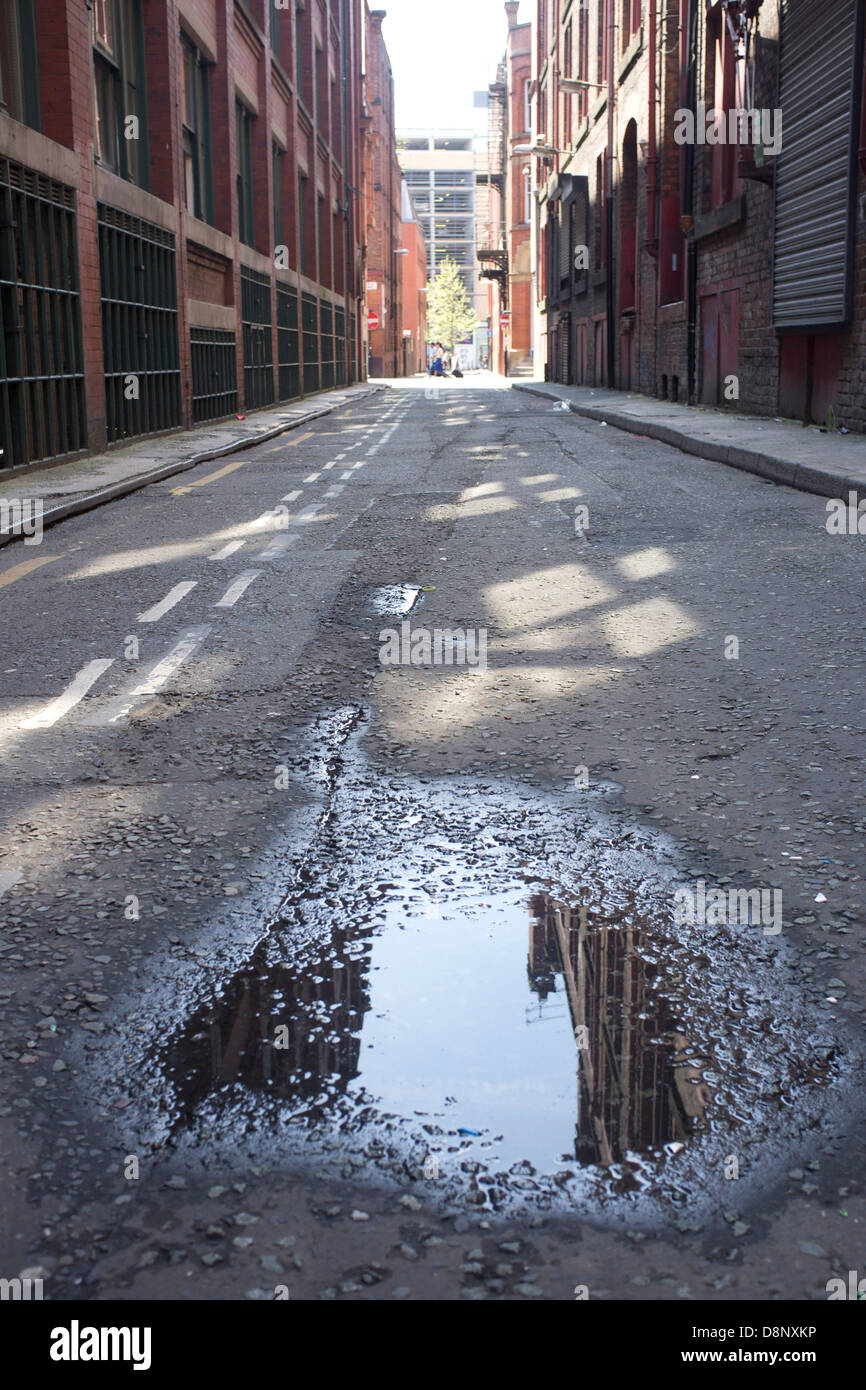 Puddle in a street in city centre Manchester, England Stock Photo - Alamy