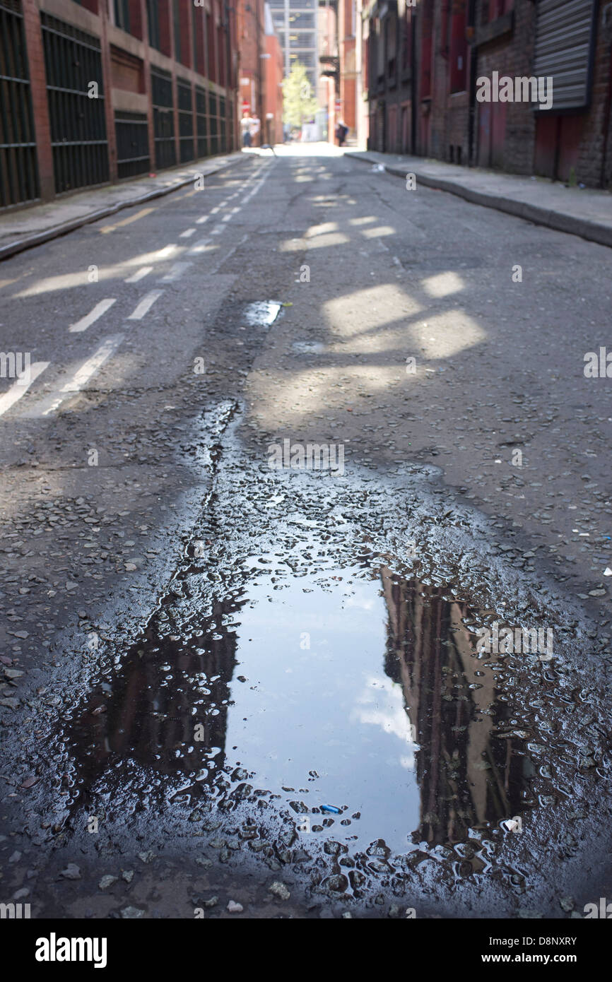 Puddle in a street in city centre Manchester, England Stock Photo - Alamy