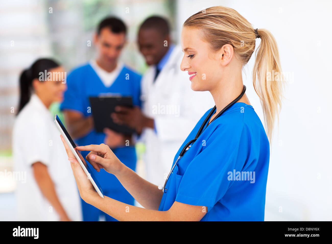 attractive young medical nurse using tablet computer Stock Photo - Alamy