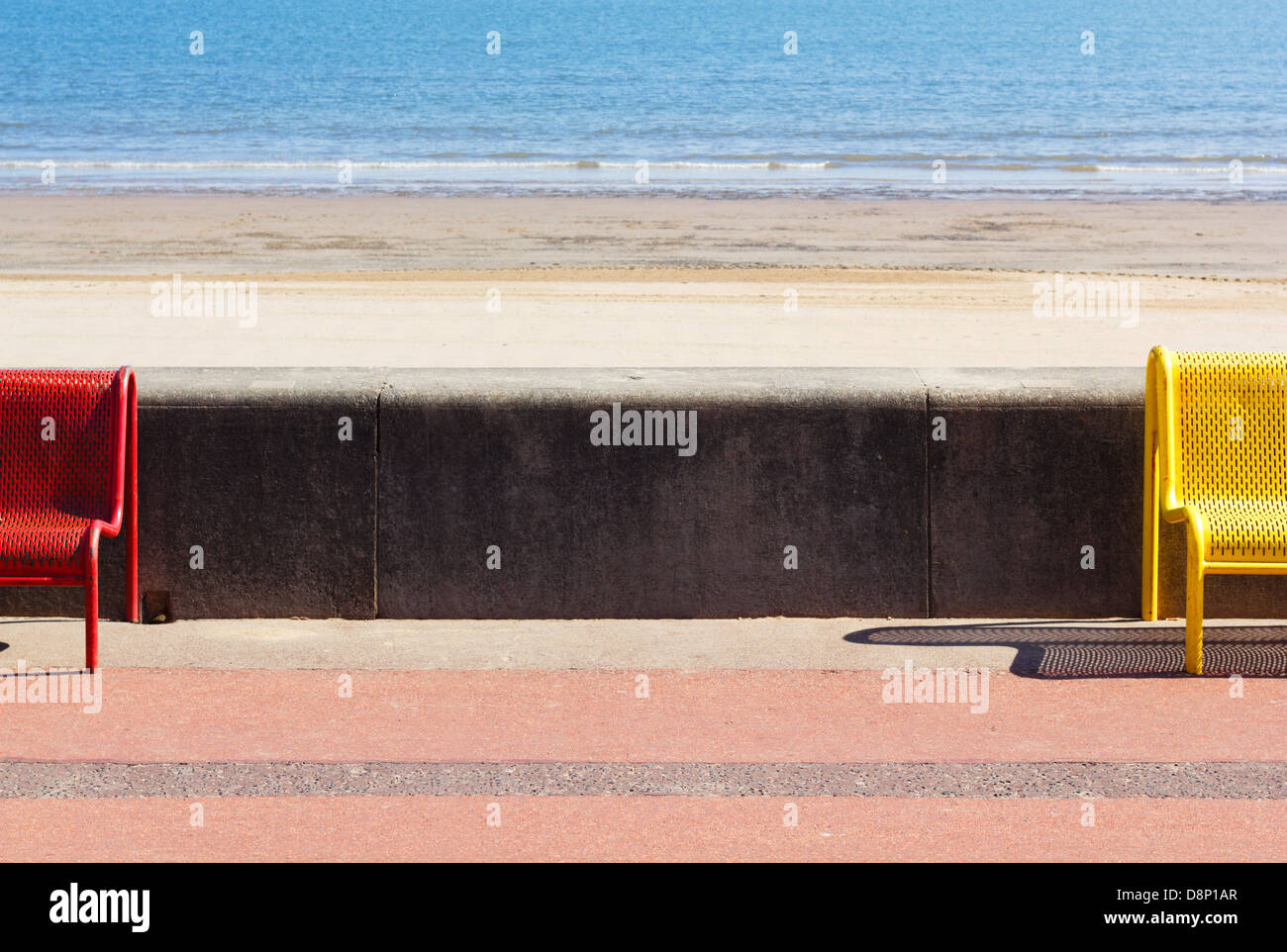 Coloured benches on beach promenade Stock Photo - Alamy