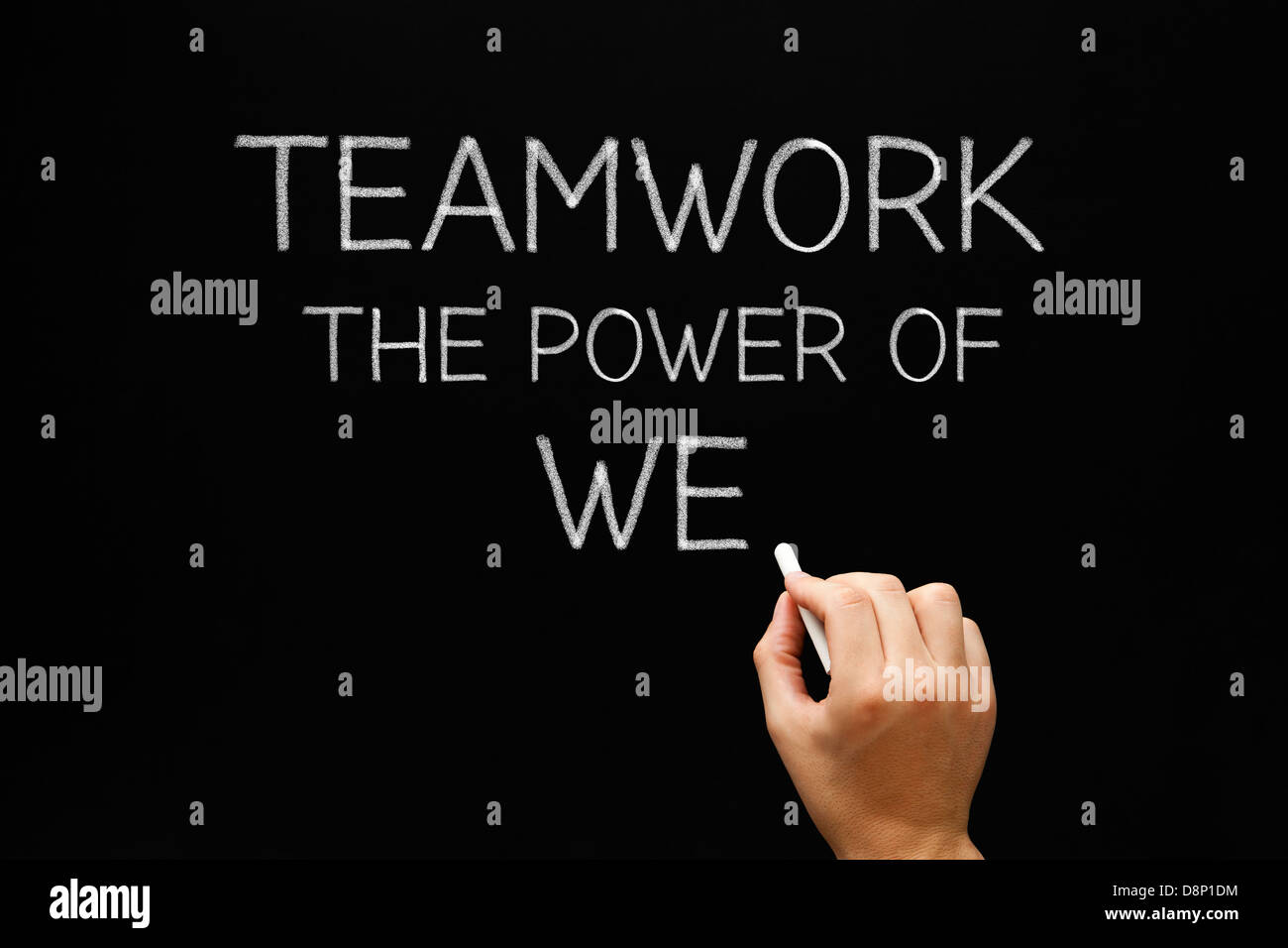 Hand writing Teamwork - The Power Of We with white chalk on a ...