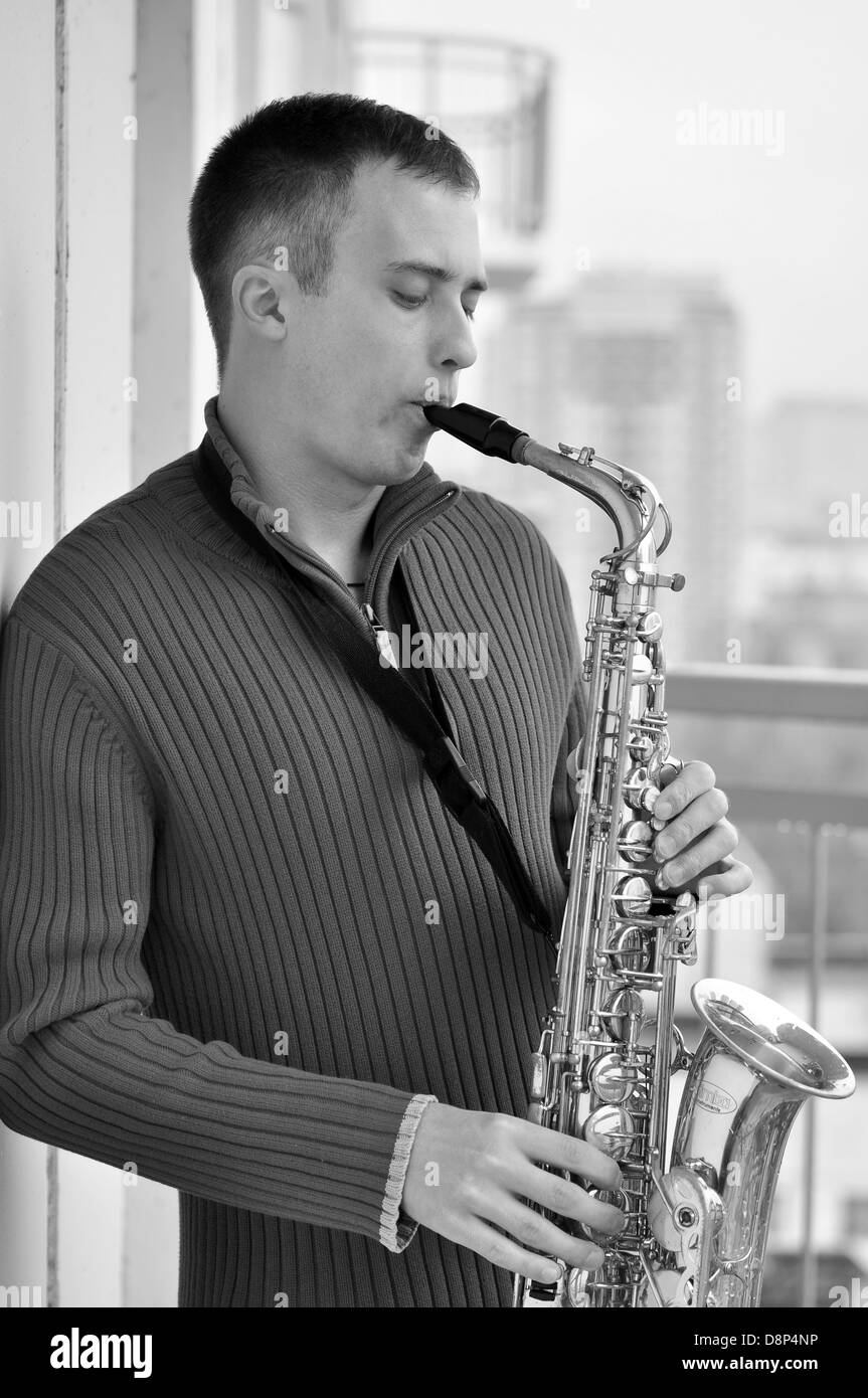 Boy playing saxophone hi-res stock photography and images - Alamy