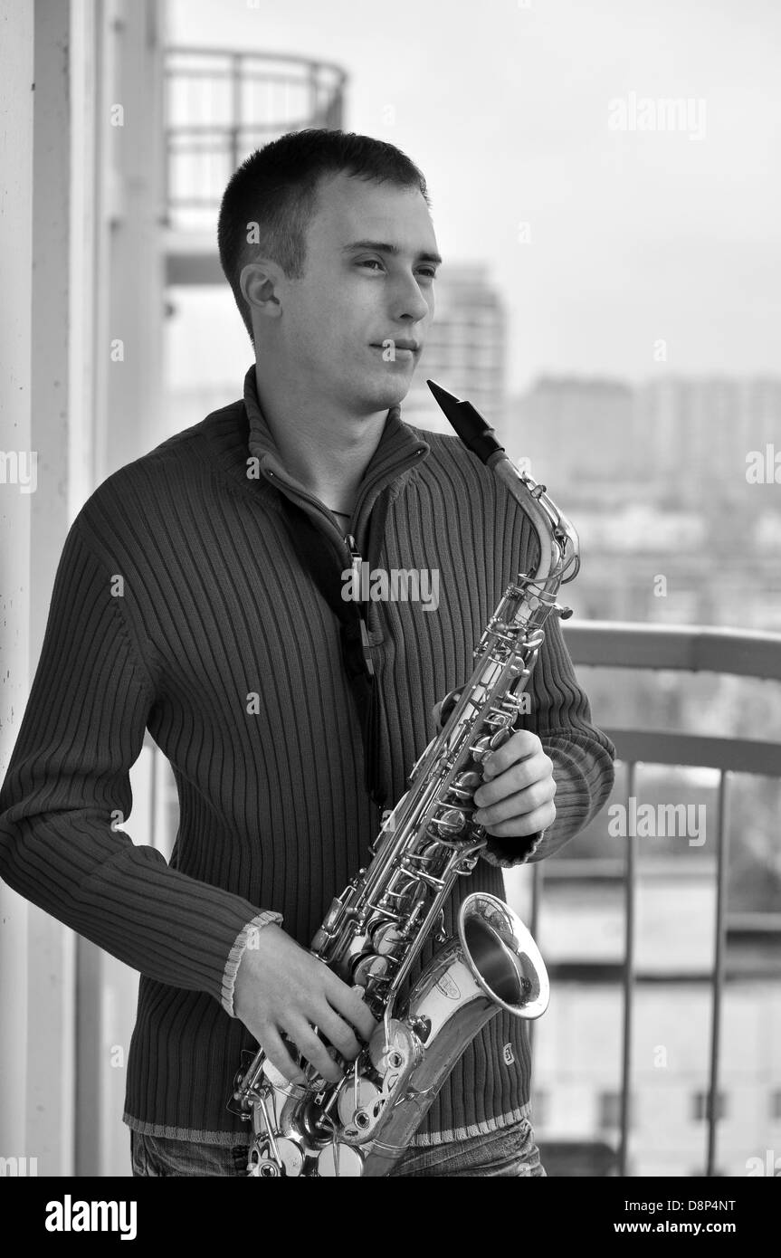 handsome young man playing on saxophone outdoor Stock Photo - Alamy