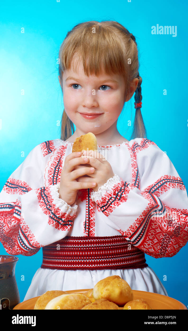 Russian little girl eats homemade pie Stock Photo - Alamy