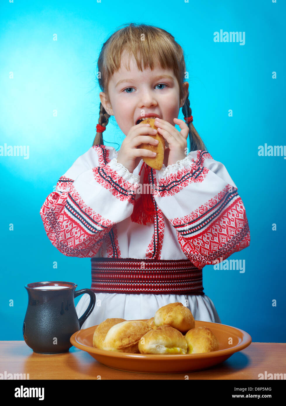 Russian little girl eats homemade pie Stock Photo - Alamy