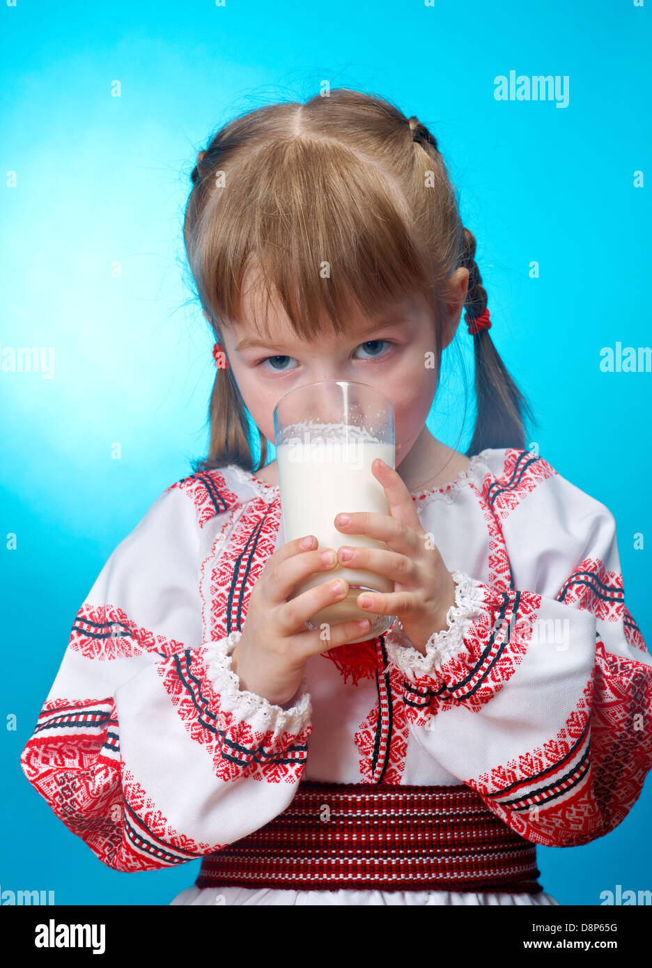 Russian little girl drinking glass of milk Stock Photo - Alamy