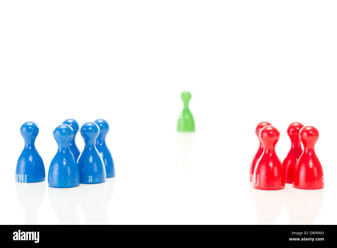 Two groups of meeples against the green meeple Stock Photo - Alamy