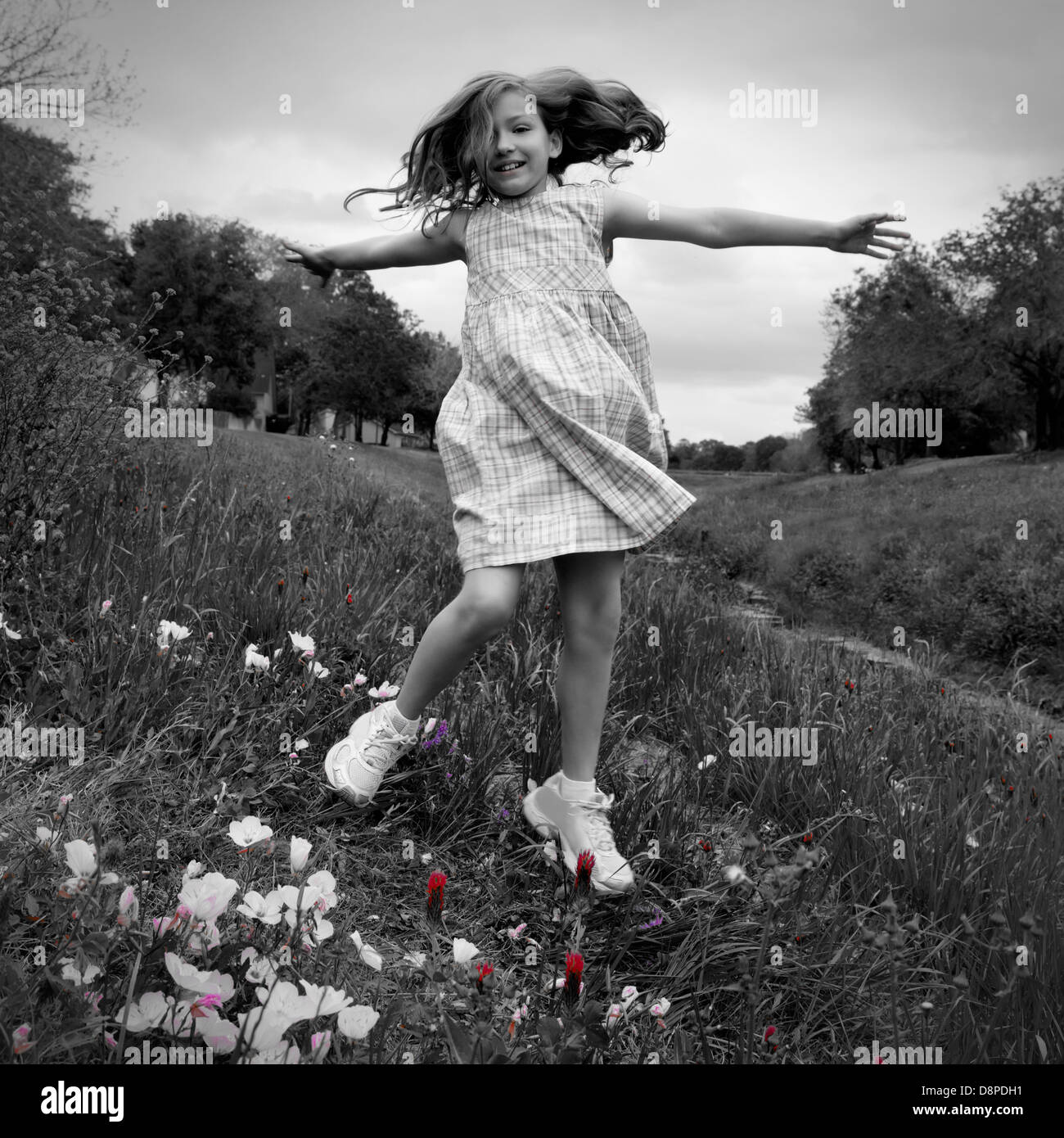 happy children girl jumping on spring poppy flowers meadow with motion ...