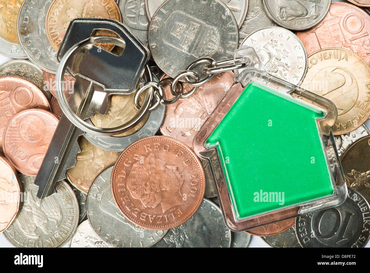 Coins and green house key ring. White isolated studio shot Stock Photo ...