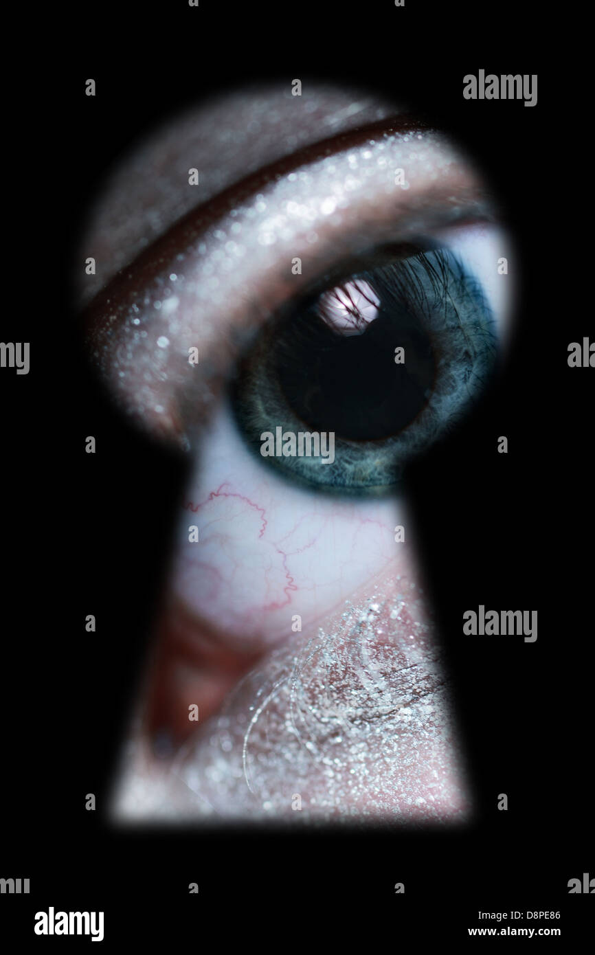 male eye spying through a keyhole macro Stock Photo - Alamy