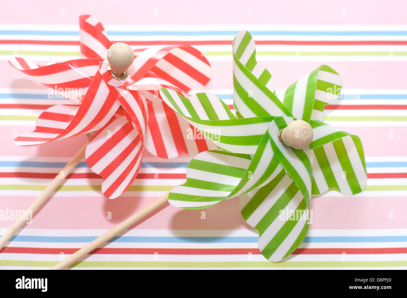 Colorful Toy Windmills on striped background Stock Photo - Alamy
