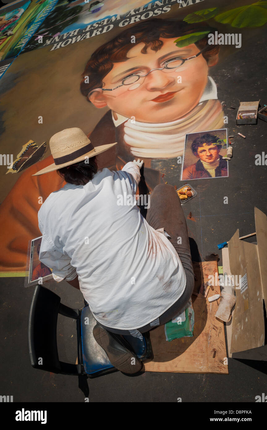 Lisa Jones, Street painting artist, works on her artwork at the 2013 ...