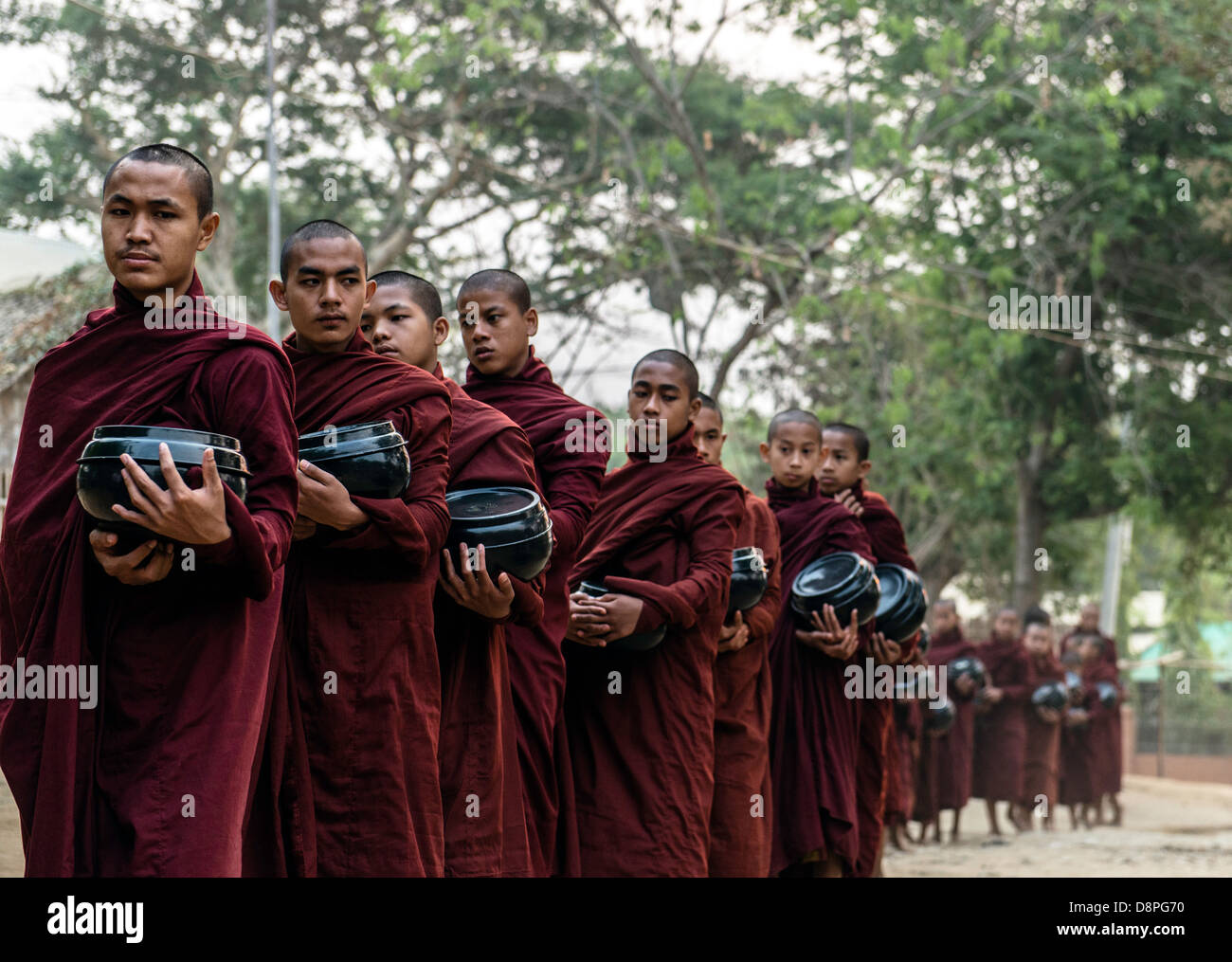 Buddhist monks collecting alms bowls of food in the morning from ...