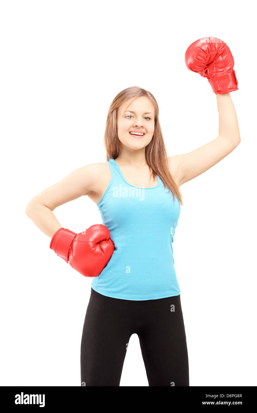 Happy female athlete wearing boxing gloves and gesturing triumph ...