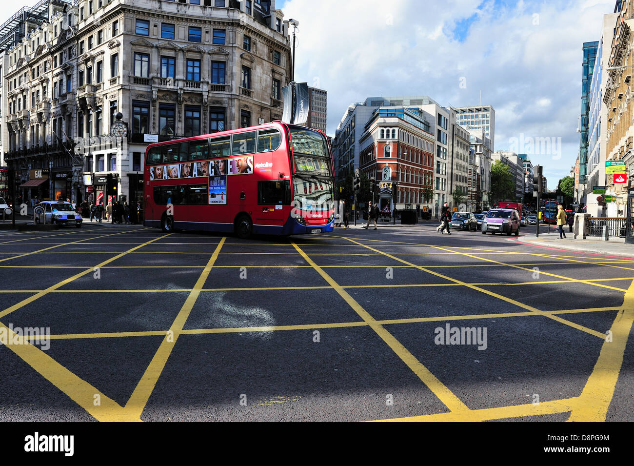 A red London double decker bus crosses at the junction of Fleet Street ...