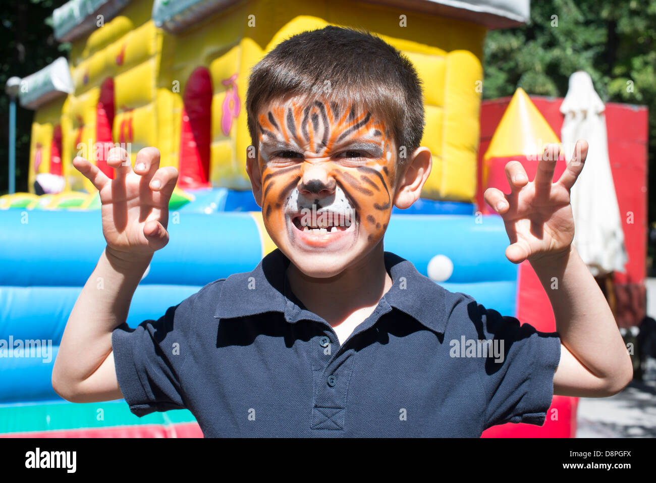 Child with painted face. Tiger paint. Boy on children's holiday Stock ...