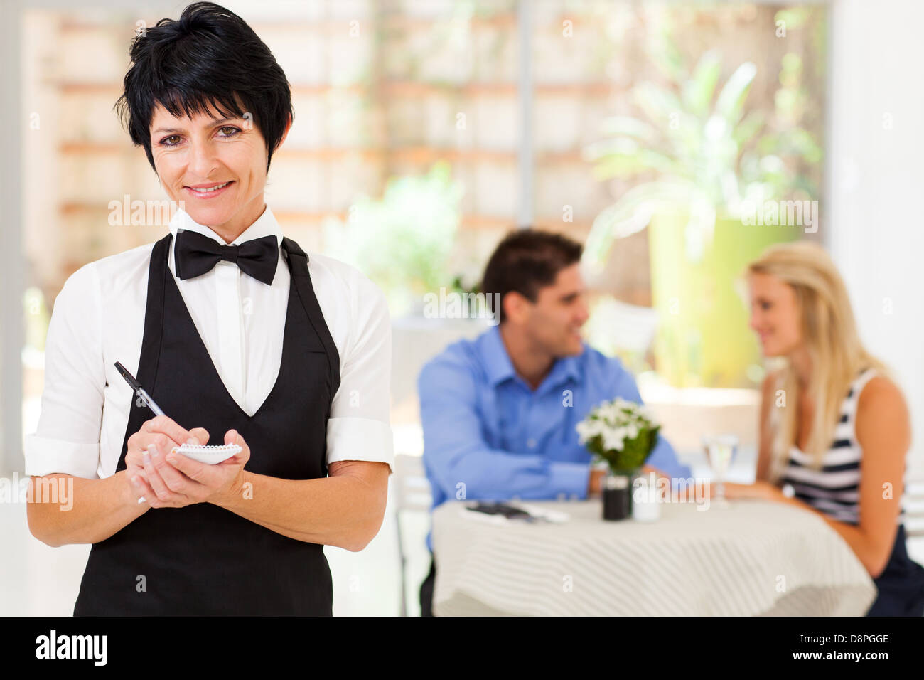 elegant mature waitress working in restaurant Stock Photo - Alamy