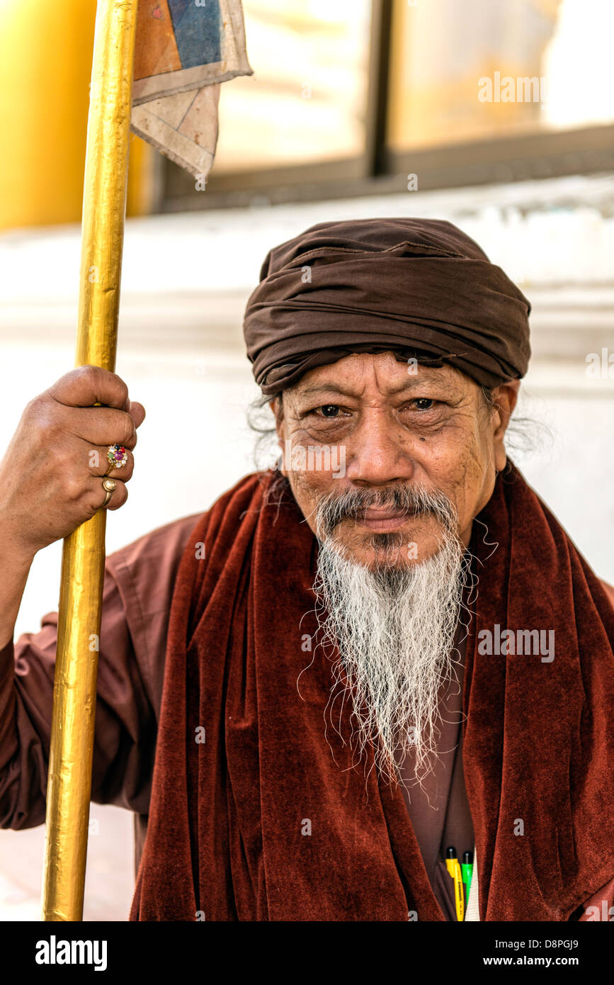Portrait of old Buddhist priest at Shwedagon Pagoda or Great Dagon ...