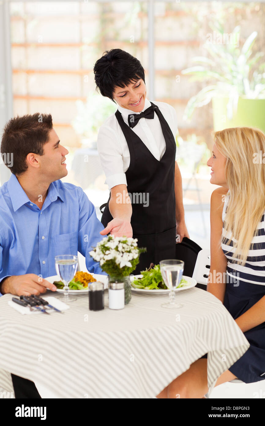 happy waitress serving customers in cafe Stock Photo - Alamy
