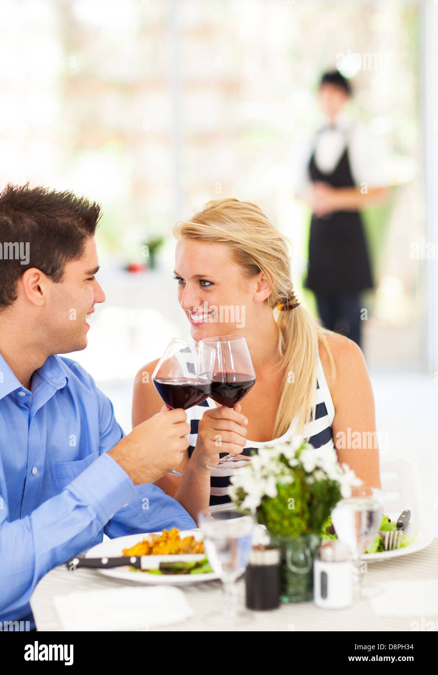 happy young couple eating out in restaurant Stock Photo - Alamy