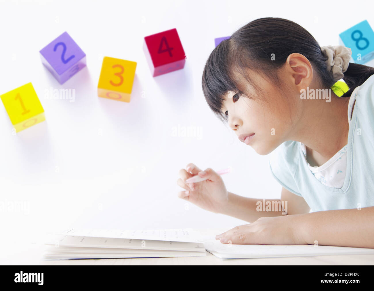 Studying elementary school girl and number blocks Stock Photo - Alamy