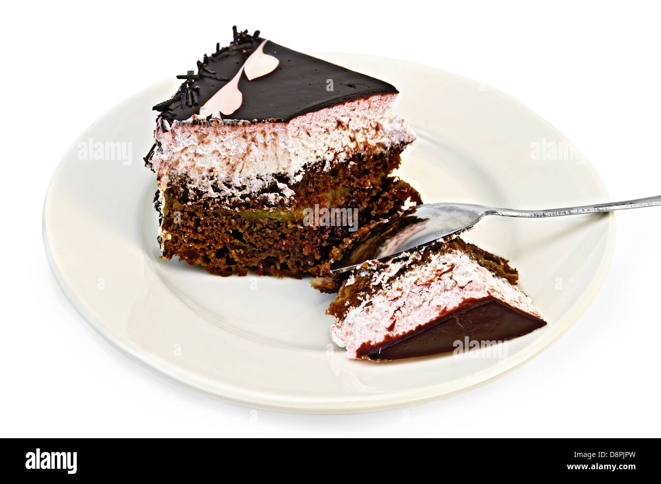 A piece of chocolate cake with pink cream with the broken spoon on a ...