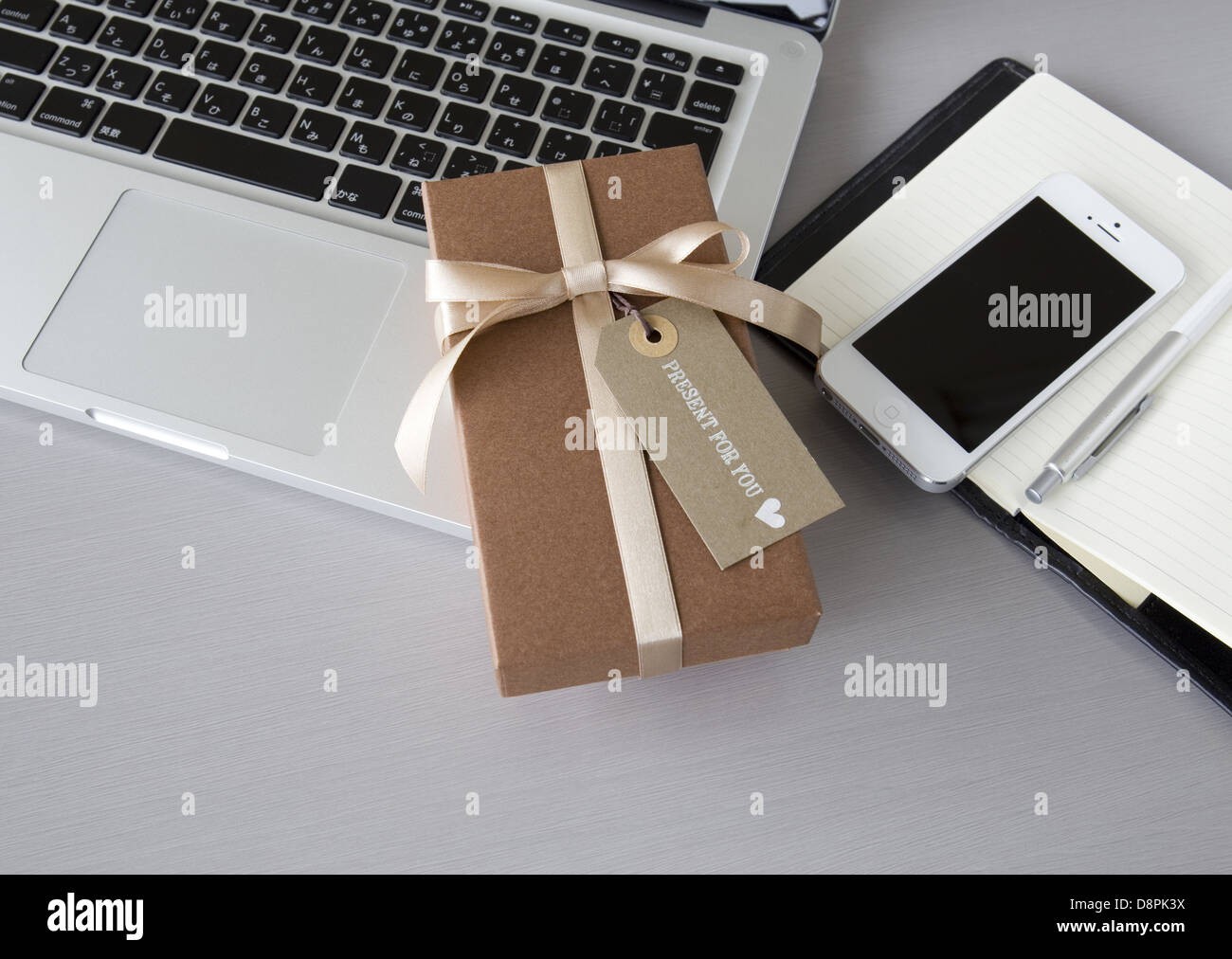 Gift box on a desk Stock Photo - Alamy