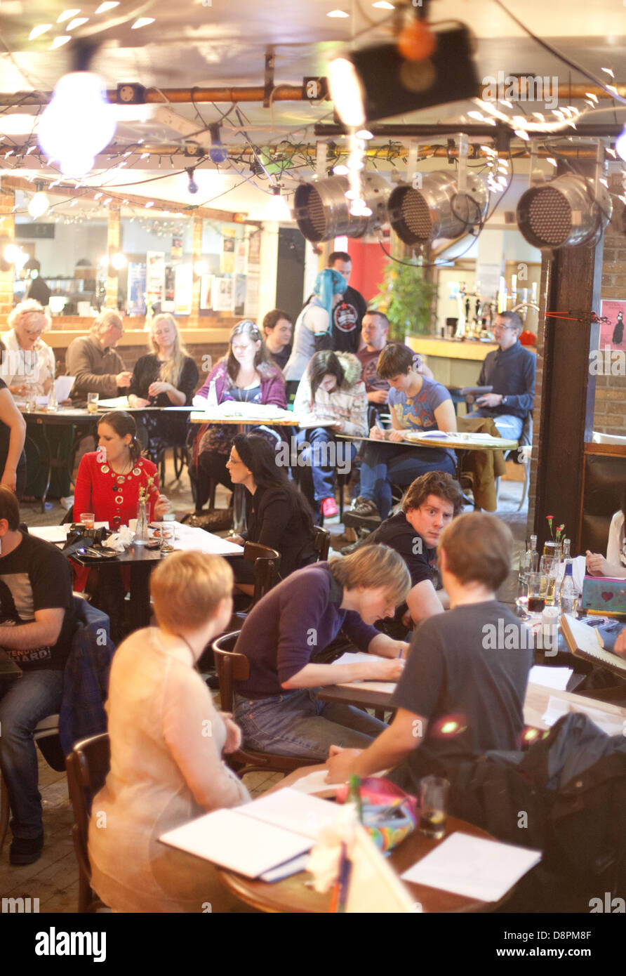 Audience relaxes in a break at a Dr Sketchy's life drawing event Stock ...