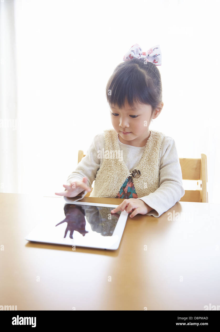 Girl using a tablet PC Stock Photo - Alamy