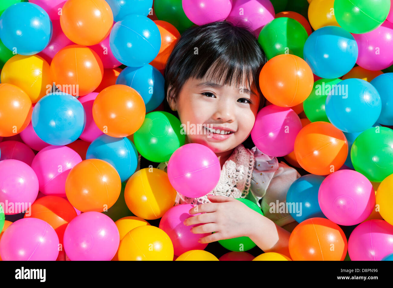 Young girl with colorful balls, portrait Stock Photo - Alamy