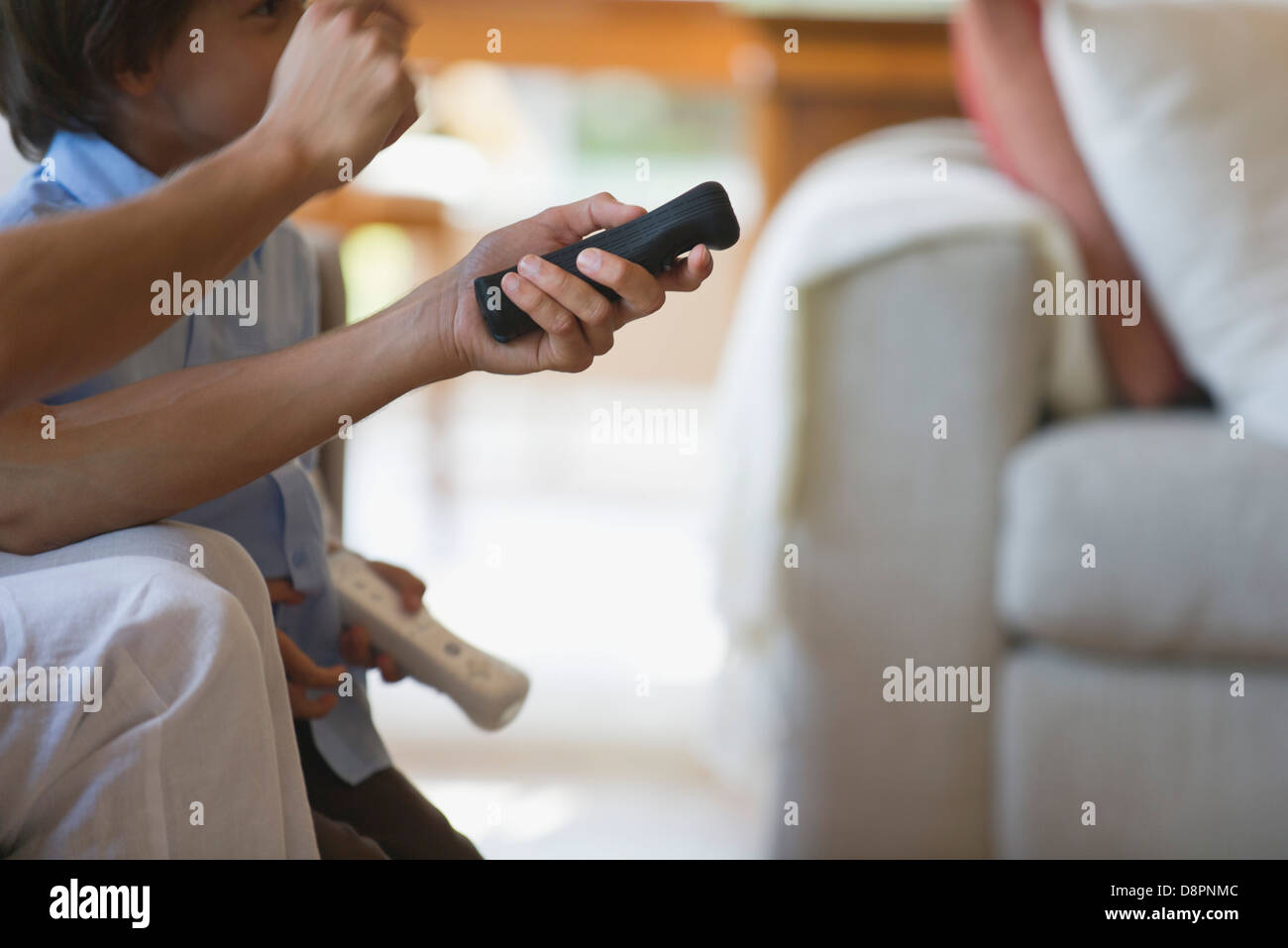 Man and child playing video game using remote controls, cropped Stock ...