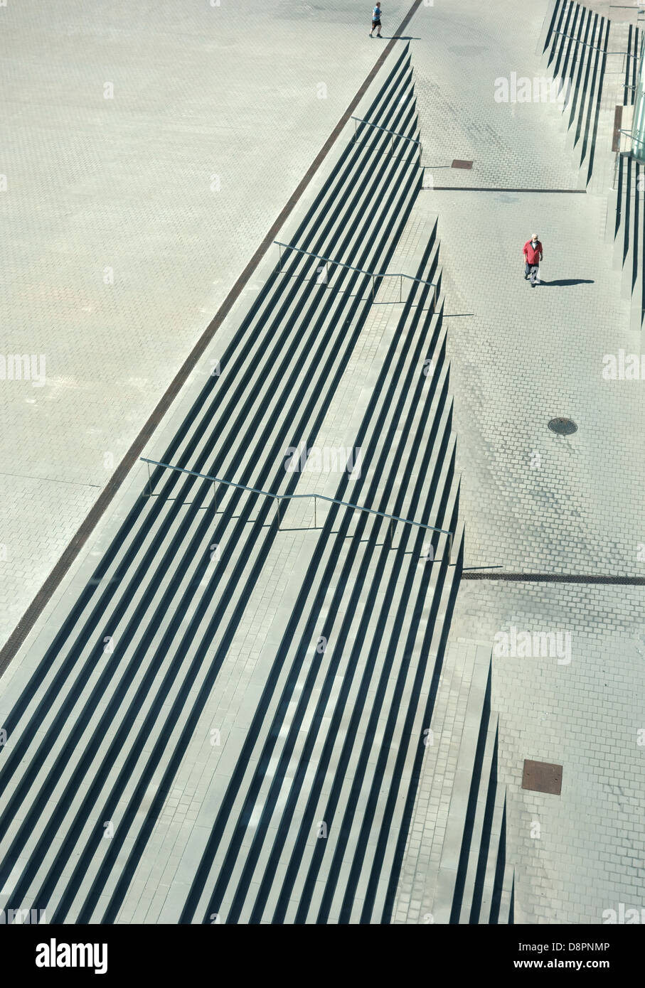 Looking down to a man walking and a man running along a path through ...