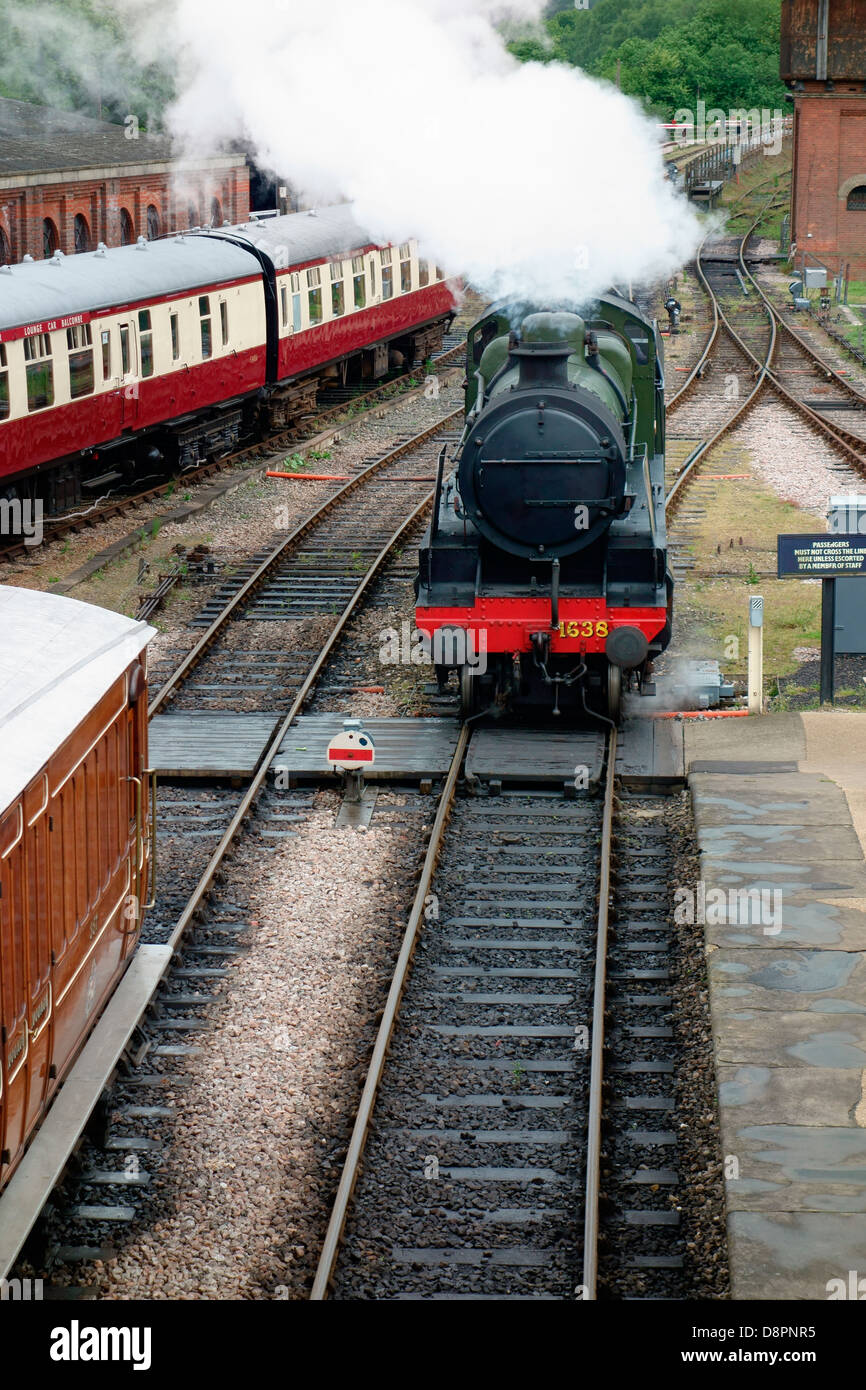 Steam train engine approaching station Stock Photo - Alamy