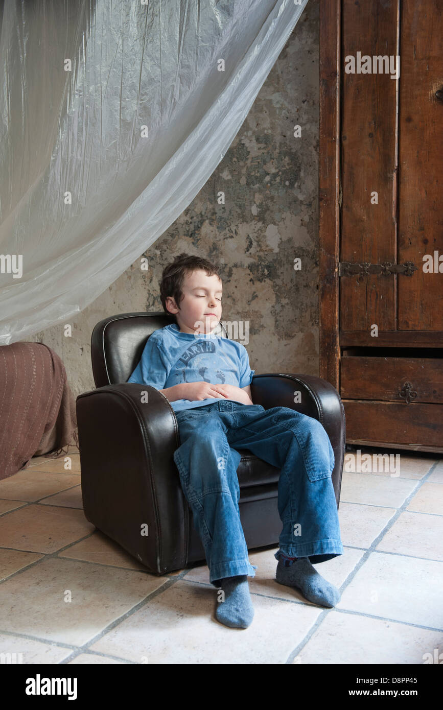 Boy napping in armchair Stock Photo - Alamy