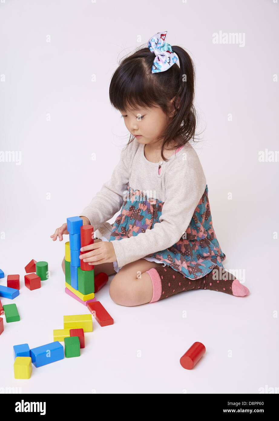 Girl playing with blocks Stock Photo - Alamy