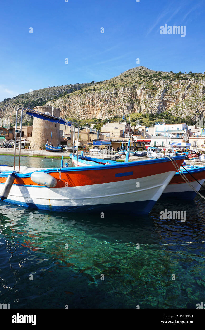 Red fishing boats on transparent water at Mondello, Sicily Stock Photo ...