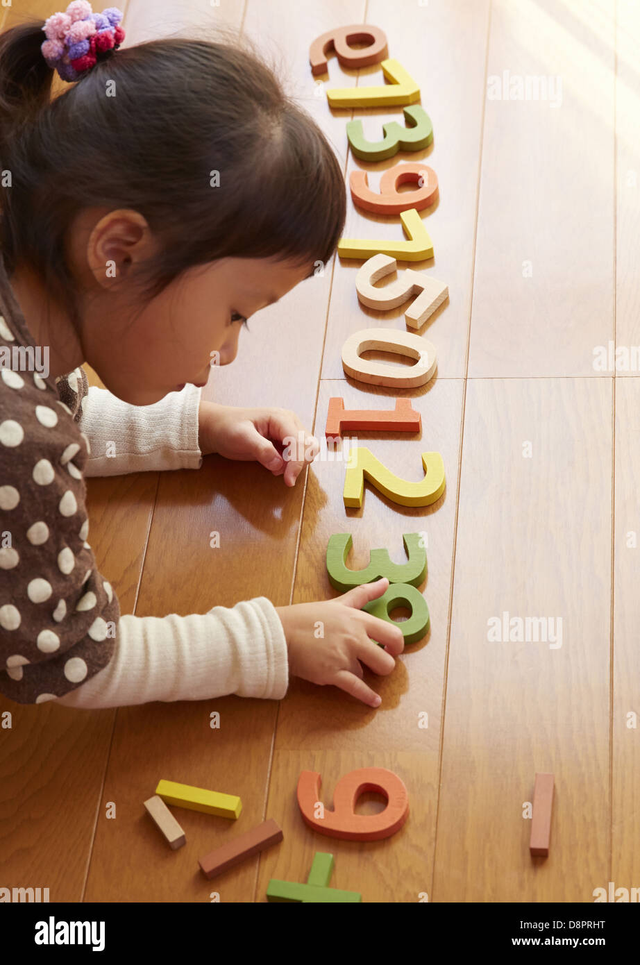 Girl playing with number blocks Stock Photo - Alamy